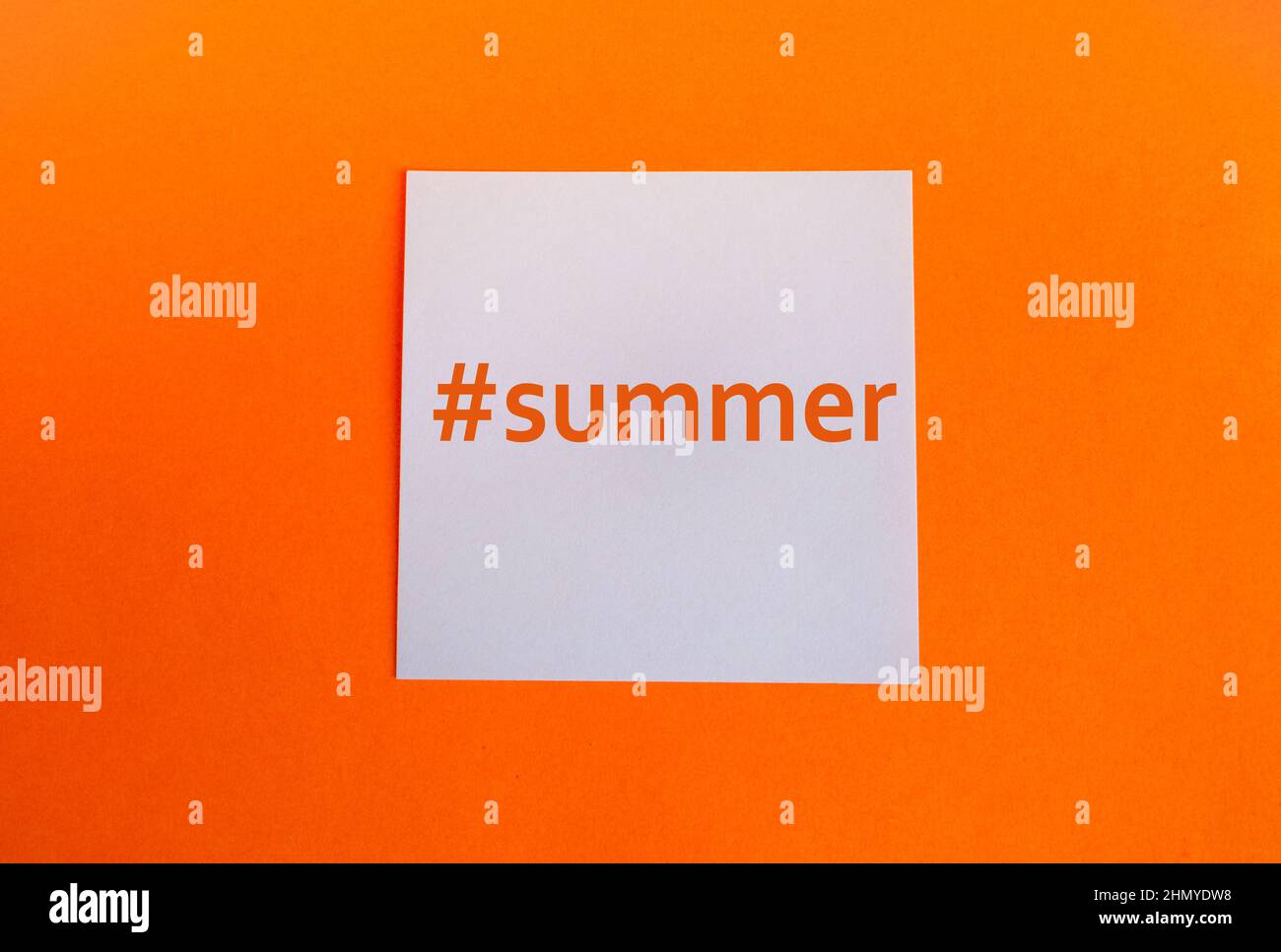 White paper square on an orange background with the hashtag summer in ...