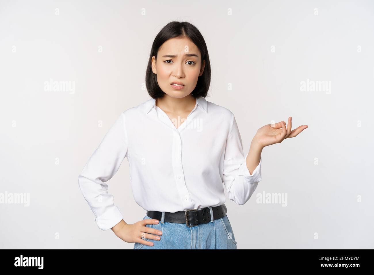 Portrait of confused asian woman asking so what, whats your problem ...