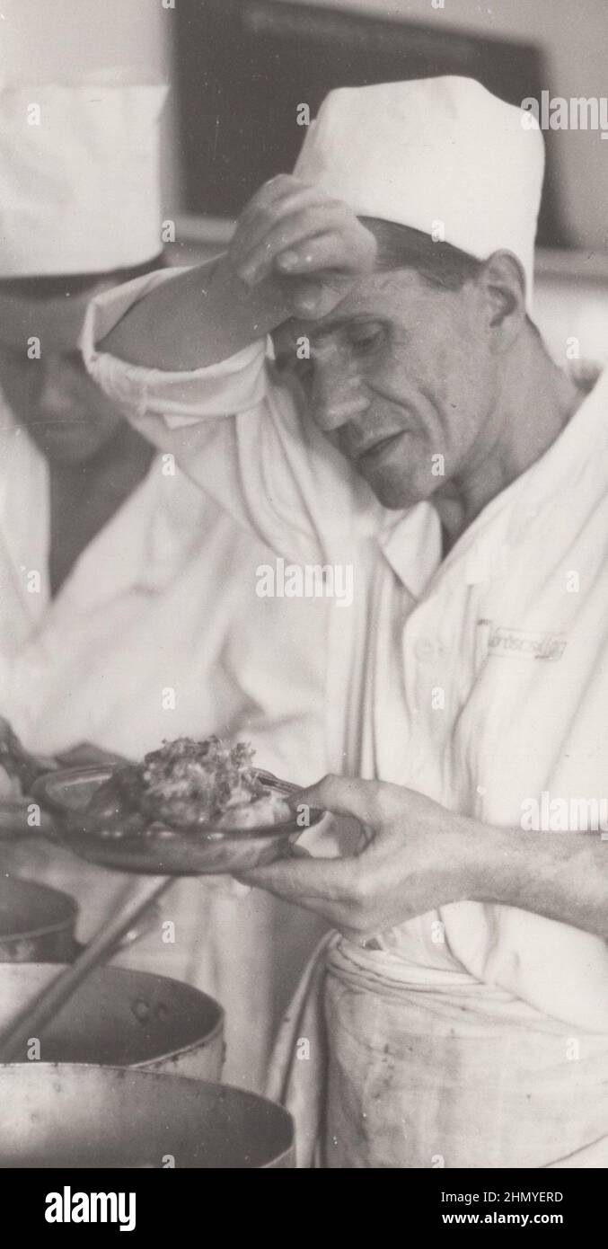 A very tired head chef who is perparing the delicious food for the ...