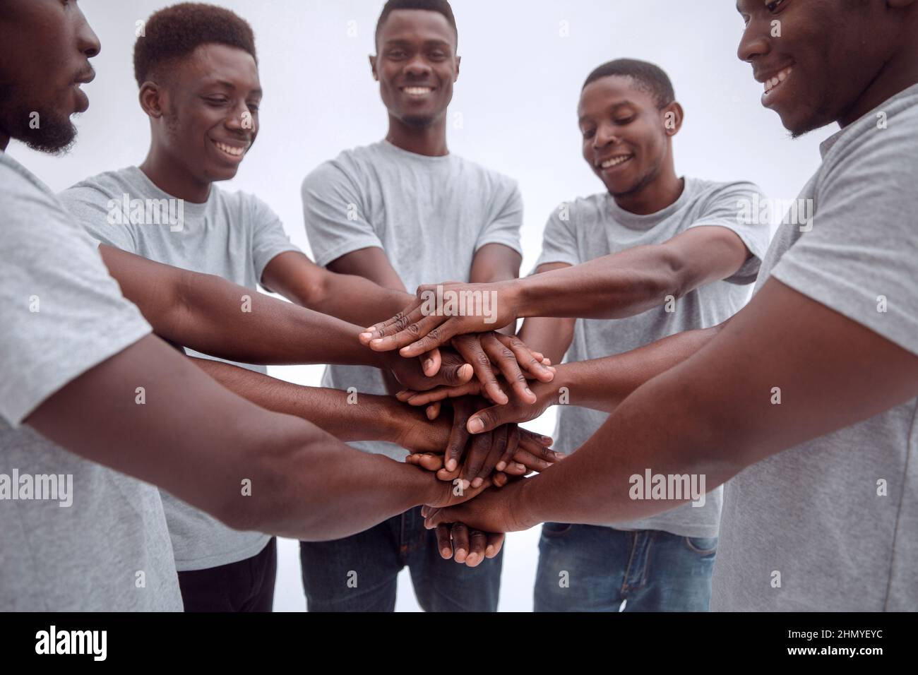 group of diverse guys making a tower out of hands Stock Photo - Alamy