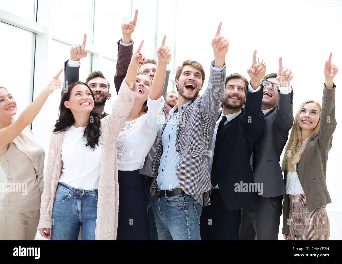 group of happy young business people pointing upwards Stock Photo - Alamy