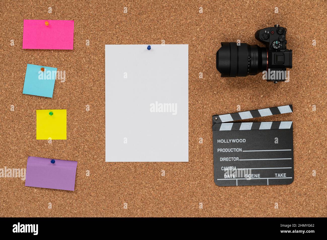 Cork board background with a clapboard and a cinema camera and color ...