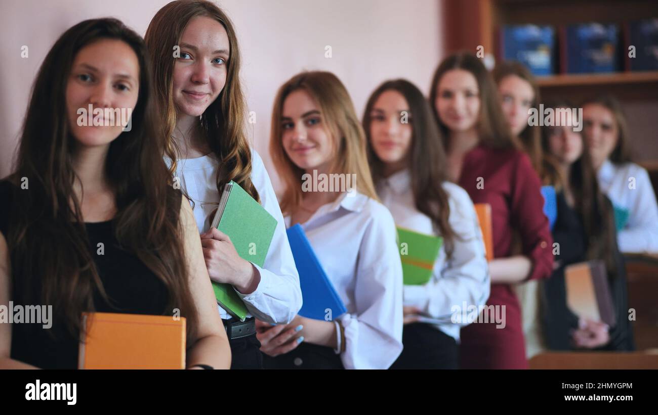 High school students are in a row in the classroom with textbooks Stock ...