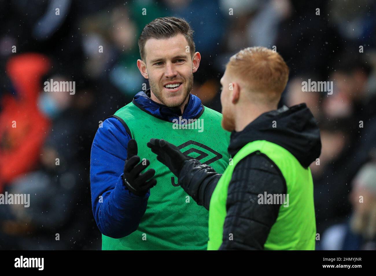 Callum Elder #3 of Hull City chats with the Fulham players as he warms ...