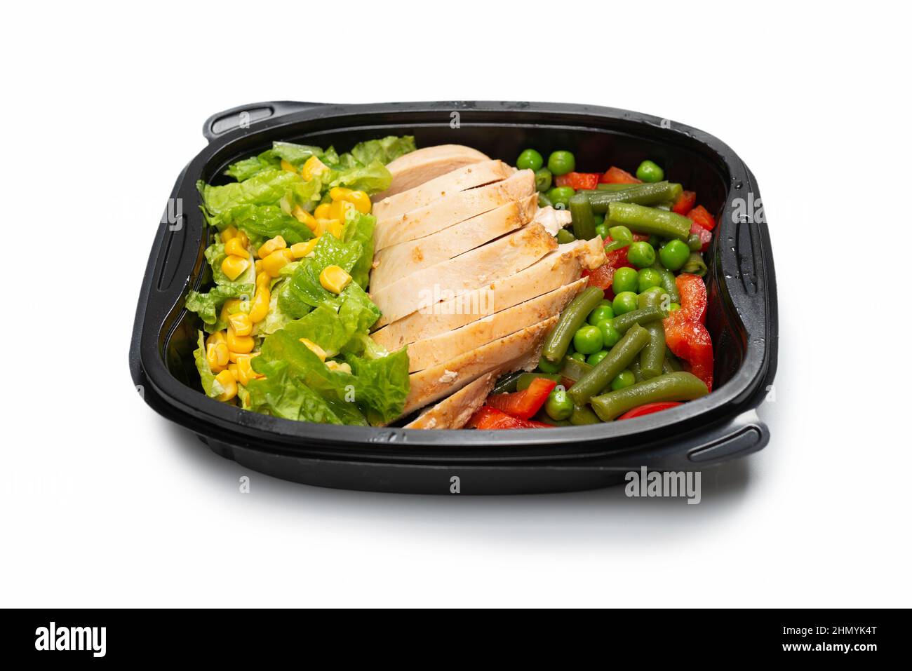 Ready food in a container. Stewed chicken, stewed vegetables. Isolated ...