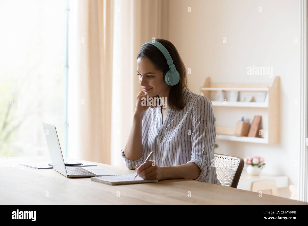 Focused happy millennial woman e-learning at home office Stock Photo ...