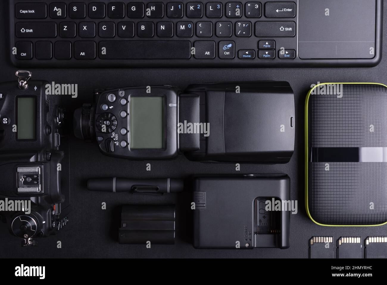 Top view of photographer work space with digital camera, flash, memory ...