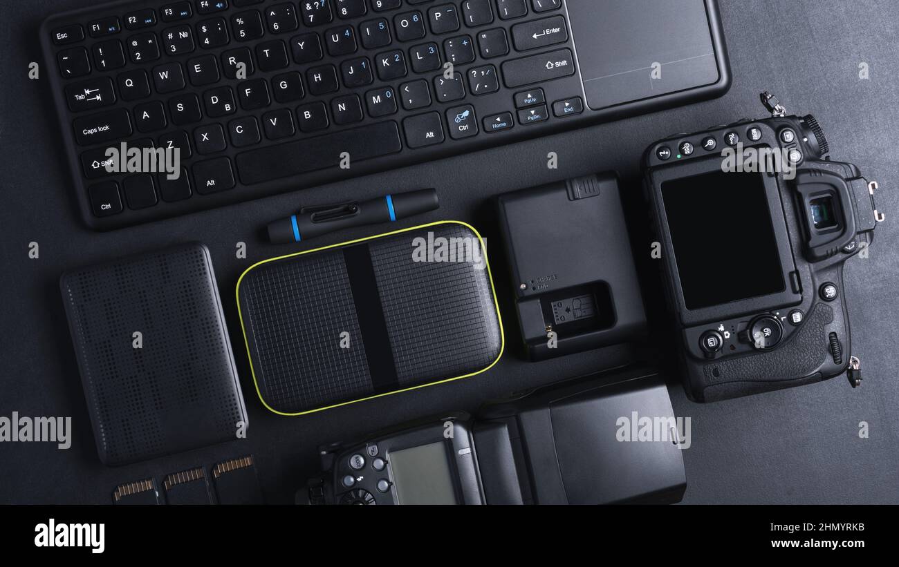 Top view of photographer work space with digital camera, flash, memory ...