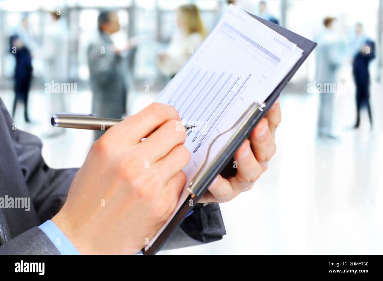 Business man writing something on the paper Stock Photo - Alamy