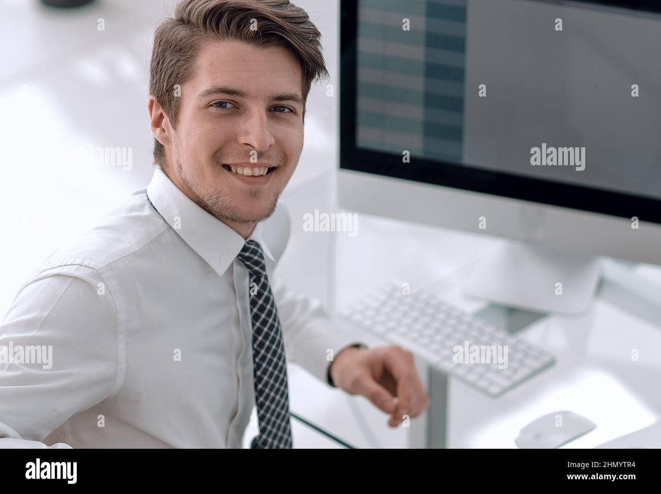 employee sitting in front of a computer screen Stock Photo - Alamy