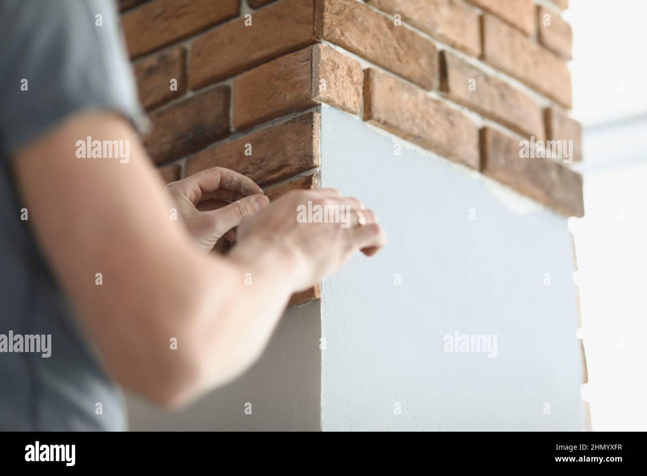 Professional builder put bricks on wall in apartment, handyman work on ...