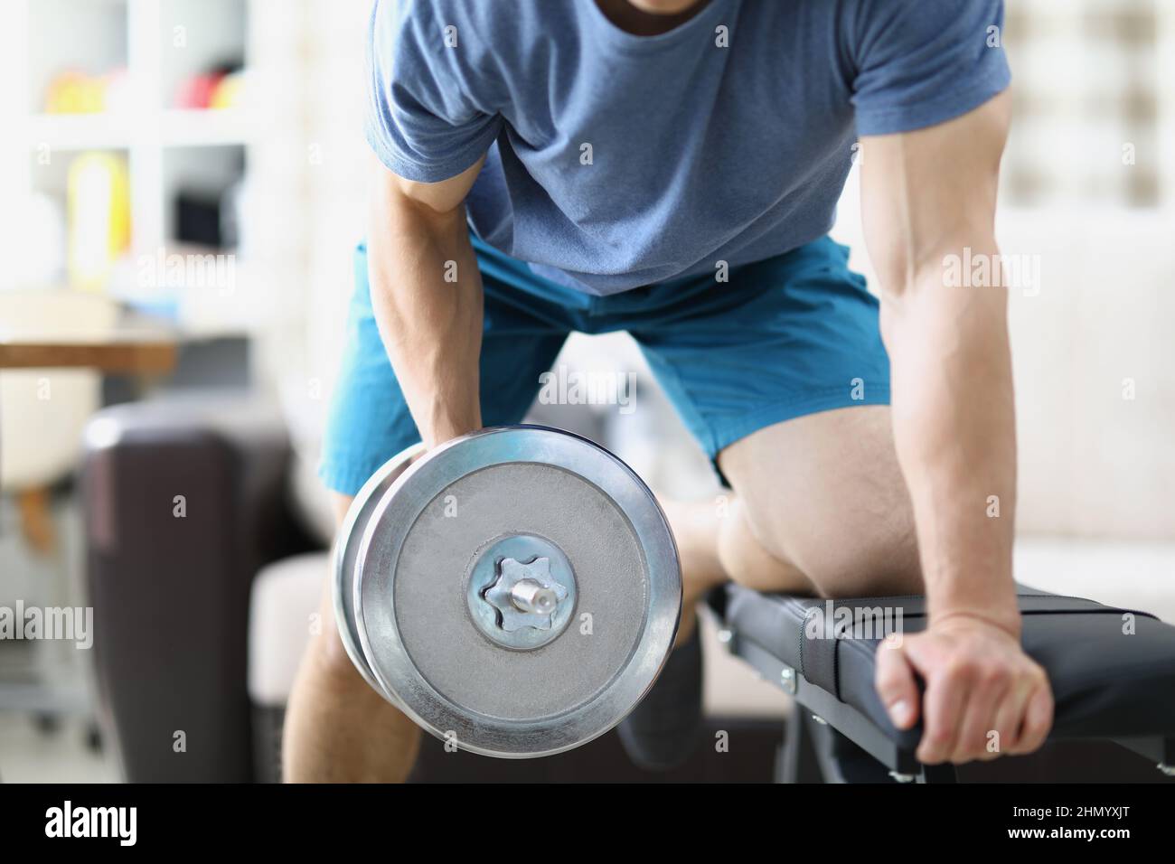 Man lifting heavy dumbbell with one hand, train body and muscles ...