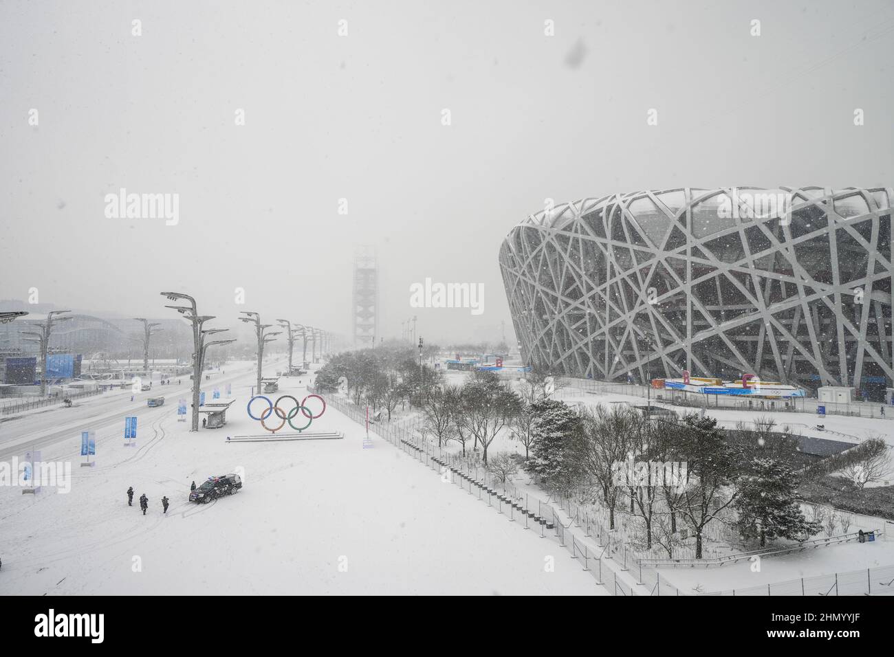 Snow covers the ground in front of the Olympic Rings outside the ...