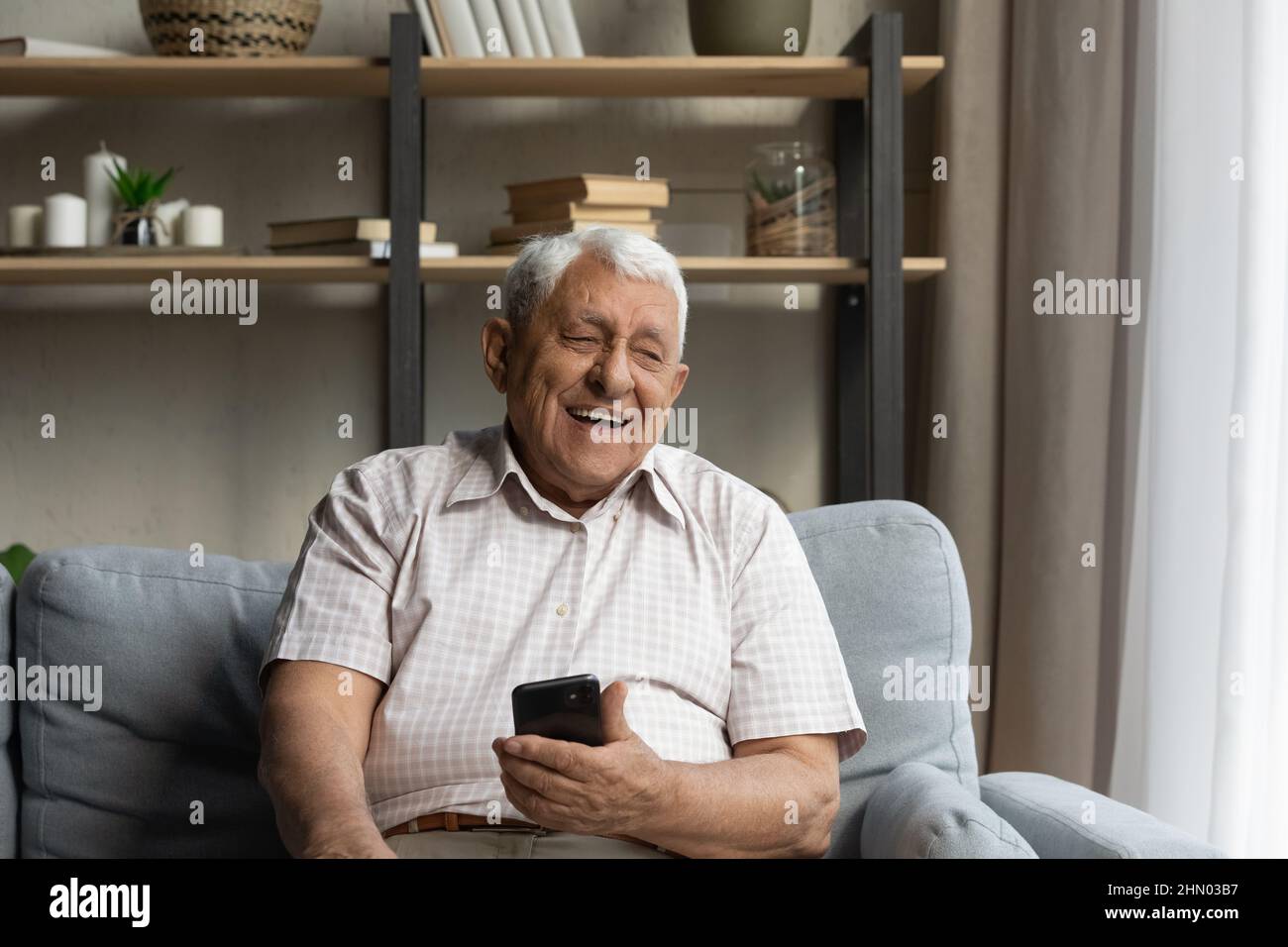 Happy older man holding, using online ecommerce app on phone Stock ...