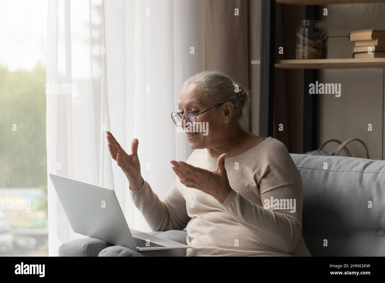 Happy elderly grandma woman talking to family on video call Stock Photo ...