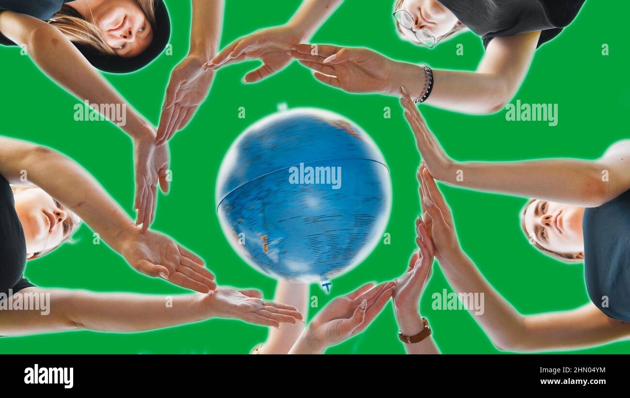 Schoolgirls hug the earth globe with their hands, making a circle out ...