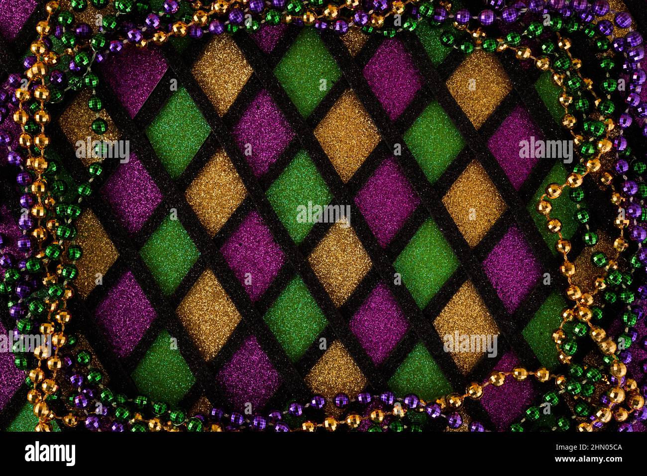 Frame of Mardi Gras Mask and colorful Mardi Gras Beads on diamond ...