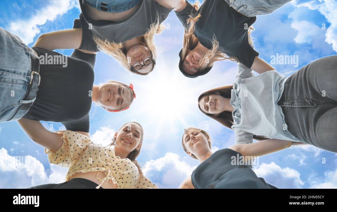 Happy girls friends hugging in a circle on the background of the fairy ...