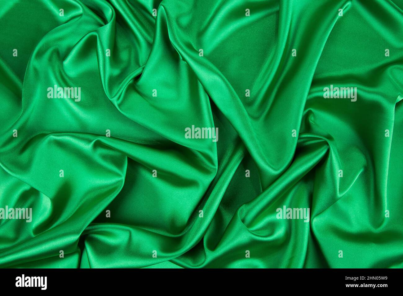 Green silk cloth with soft folds. Whole background Stock Photo - Alamy