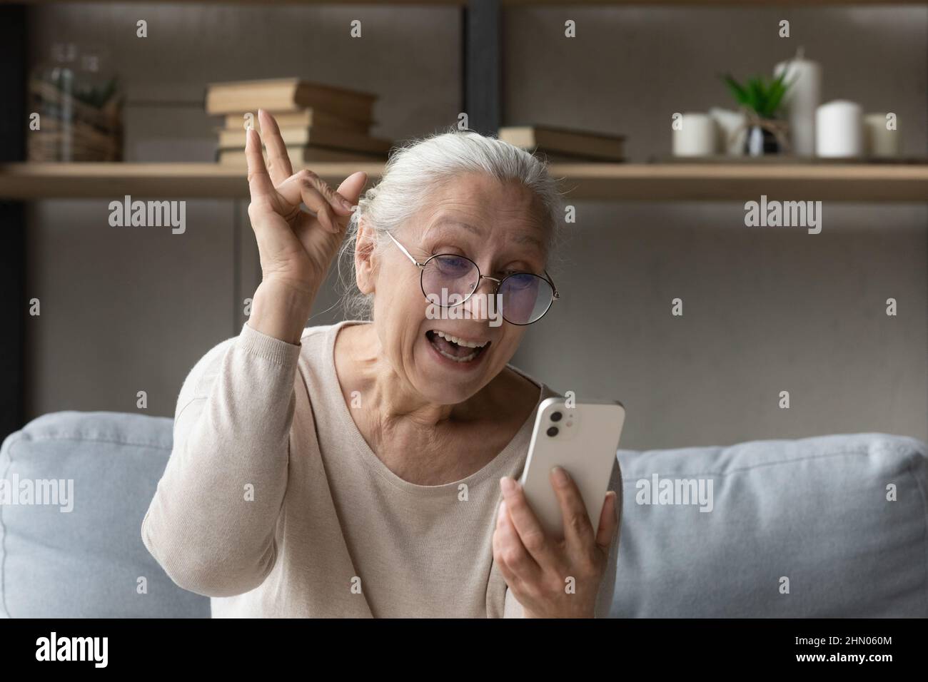 Excited freaky grandma talking on video call to grandchildren Stock ...
