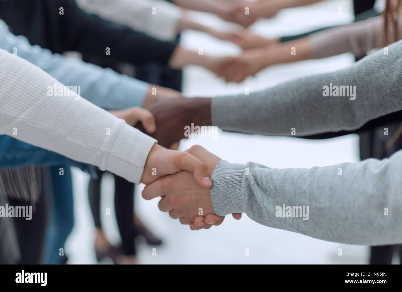diverse young people shaking hands with each other Stock Photo - Alamy