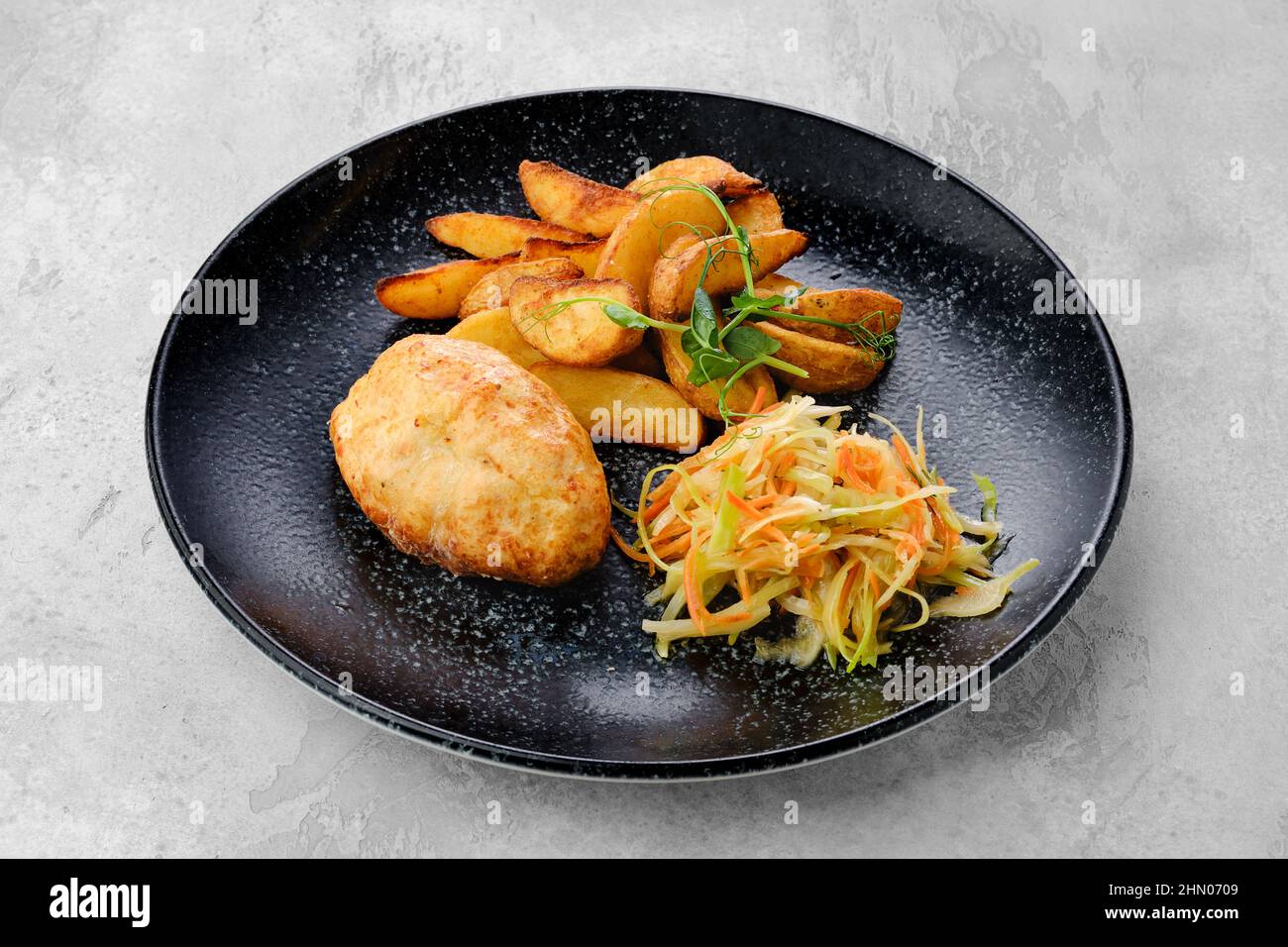 Kiev cutlet stuffed with cheese and butter served with fried potato ...