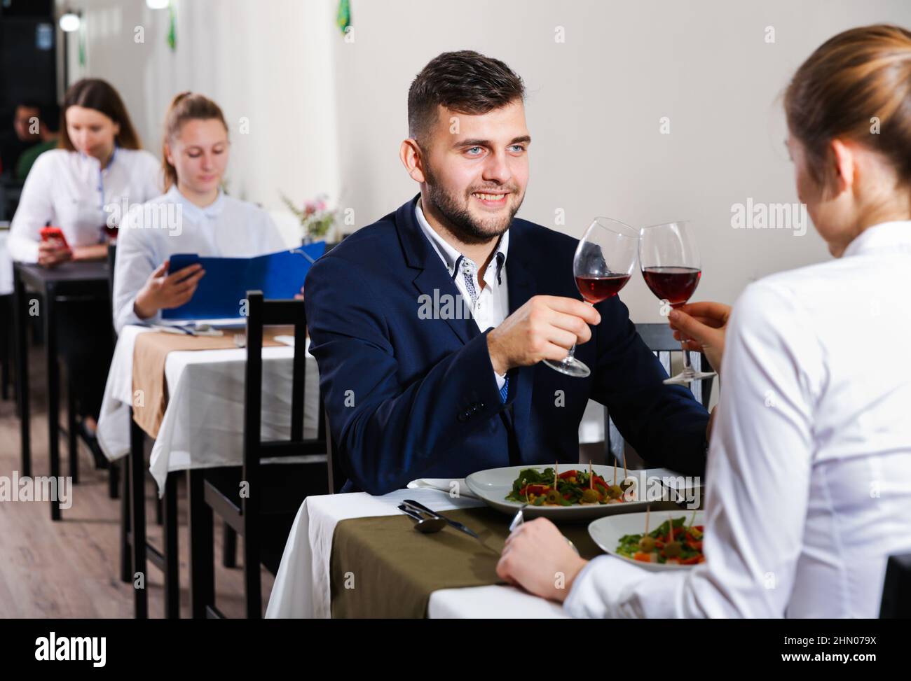 Gentleman with elegant woman are having dinner in luxury restaurante ...