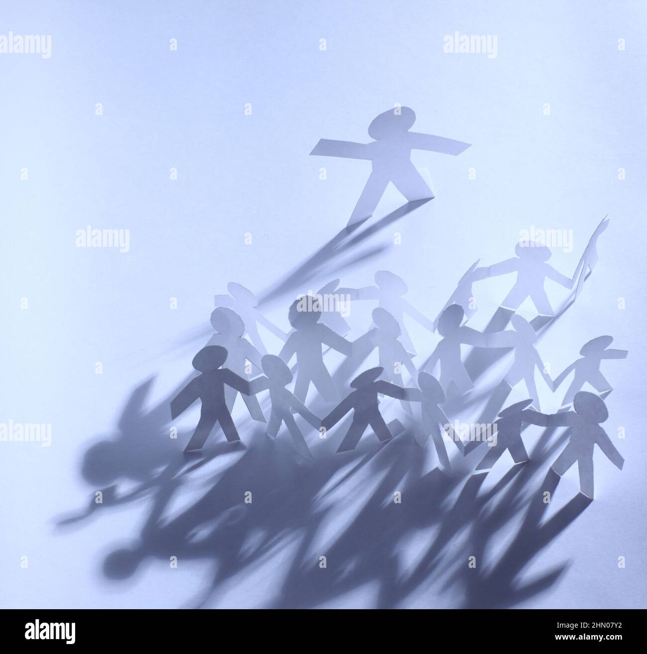 A group paper people holding hands indicating community support ...