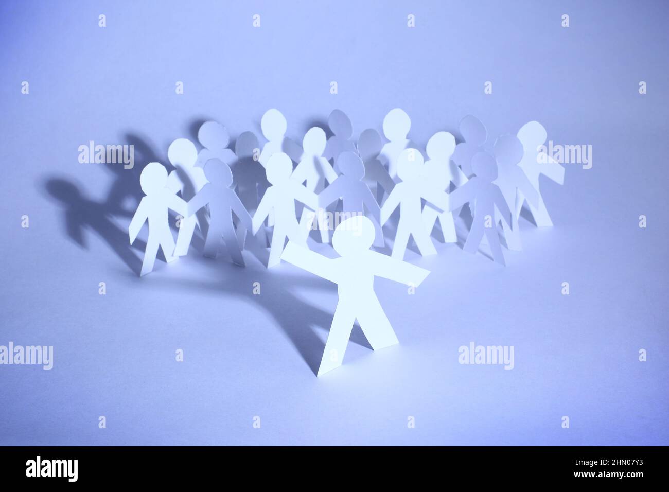 A group paper people holding hands indicating community support ...