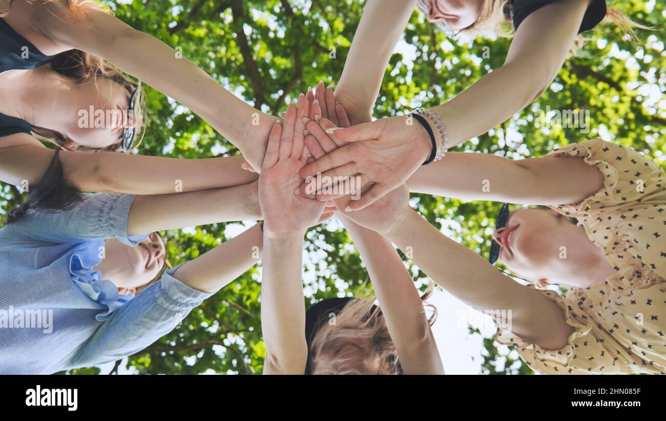 Group of female hands together in the park Stock Photo - Alamy