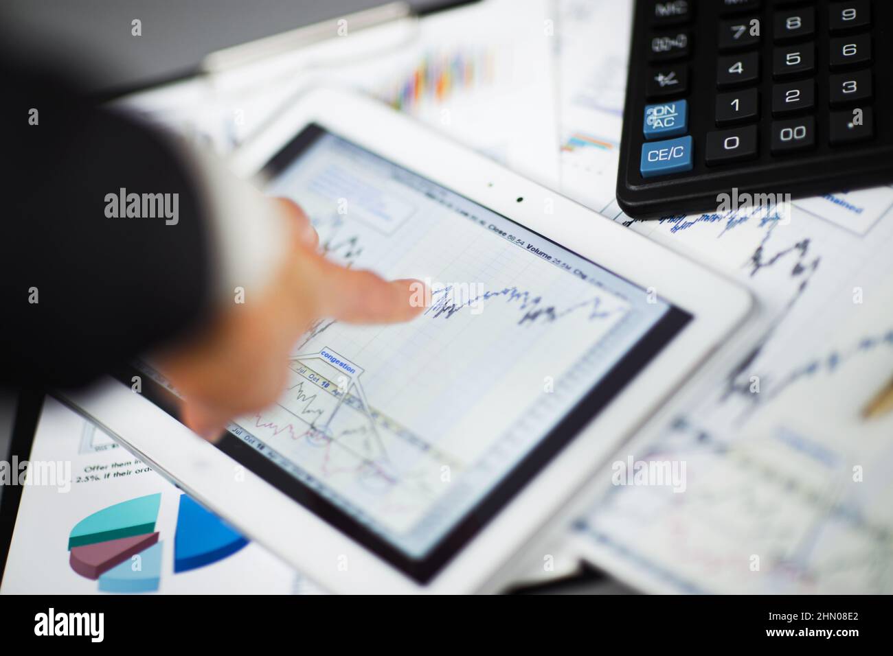 Tablet computer and financial charts Stock Photo - Alamy
