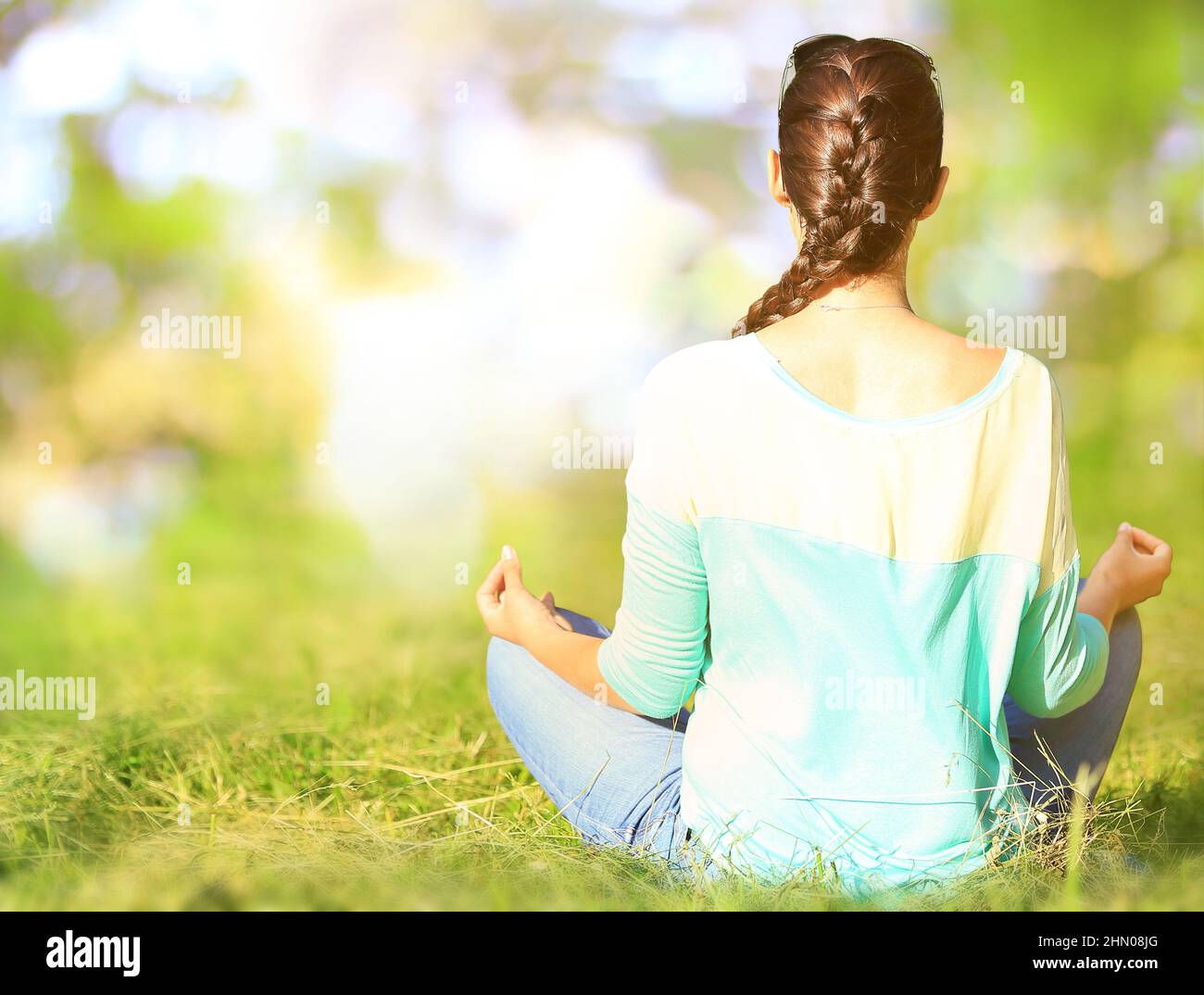 Attractive young woman in a lotus position Stock Photo - Alamy