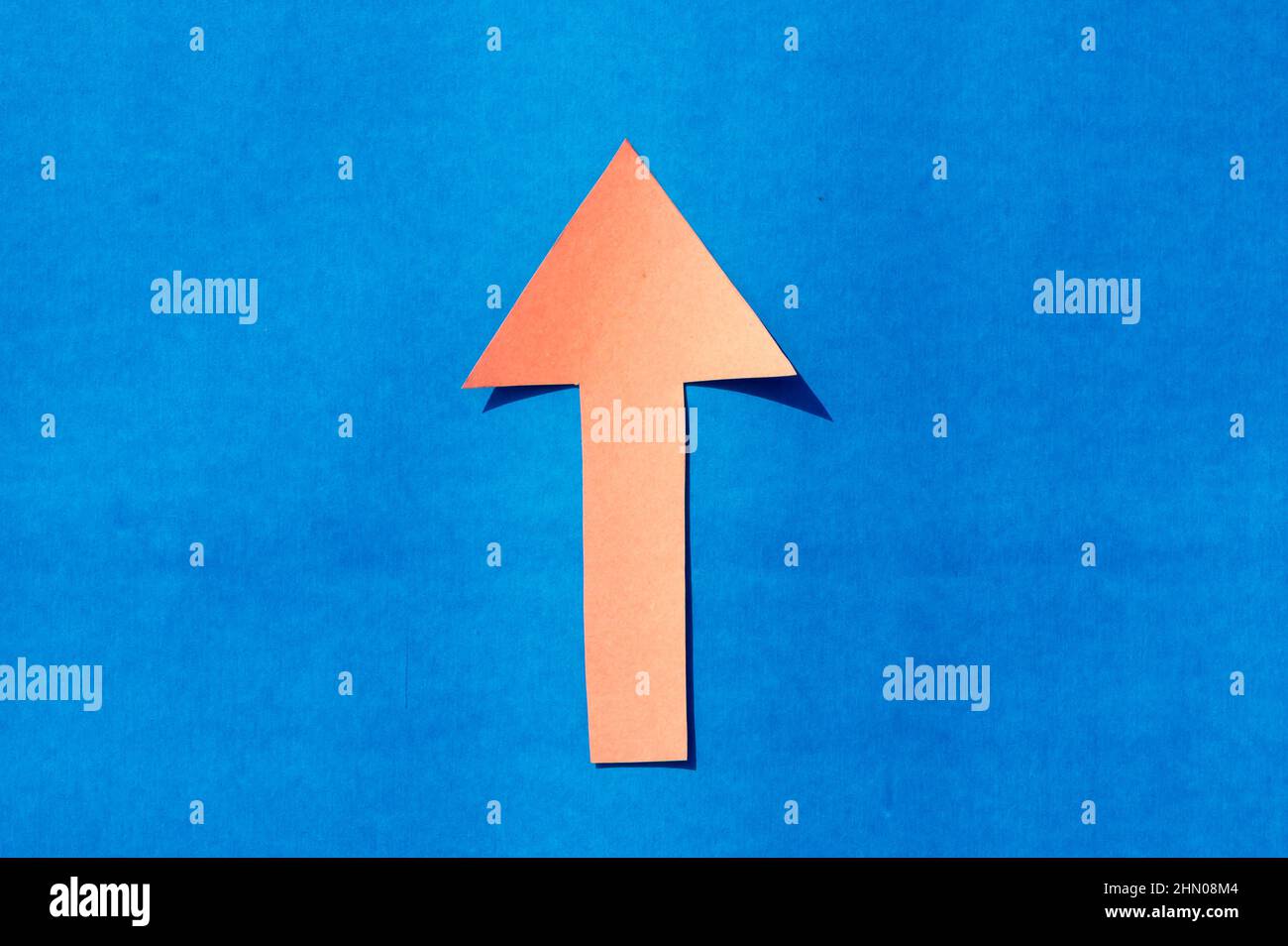 A up facing arrow symbol indicating upward direction. Isolated on blue ...