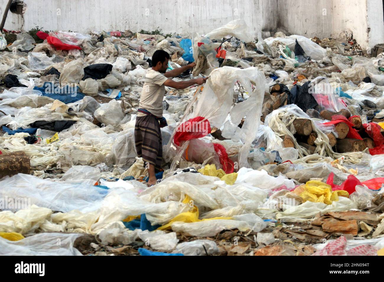 FEBRUARY 11,2022,DHAKA,BANGLADESH- Man is seen checking wasted ...