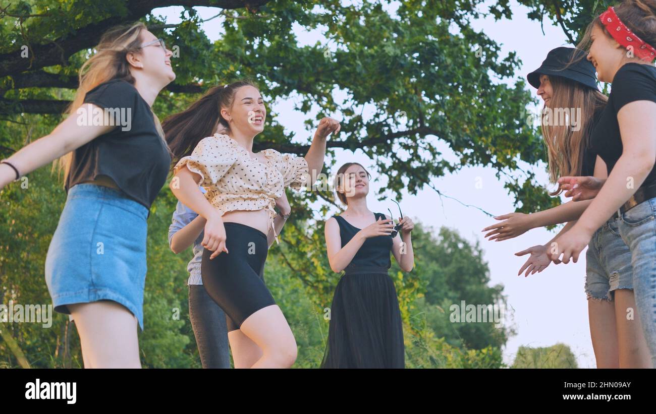 Girls are dancing outside the city on a picnic Stock Photo - Alamy