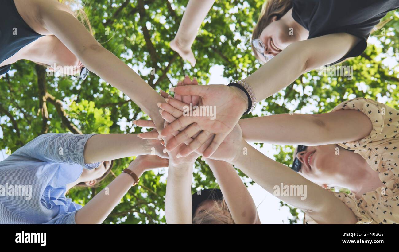 Group of female hands together in the park Stock Photo - Alamy