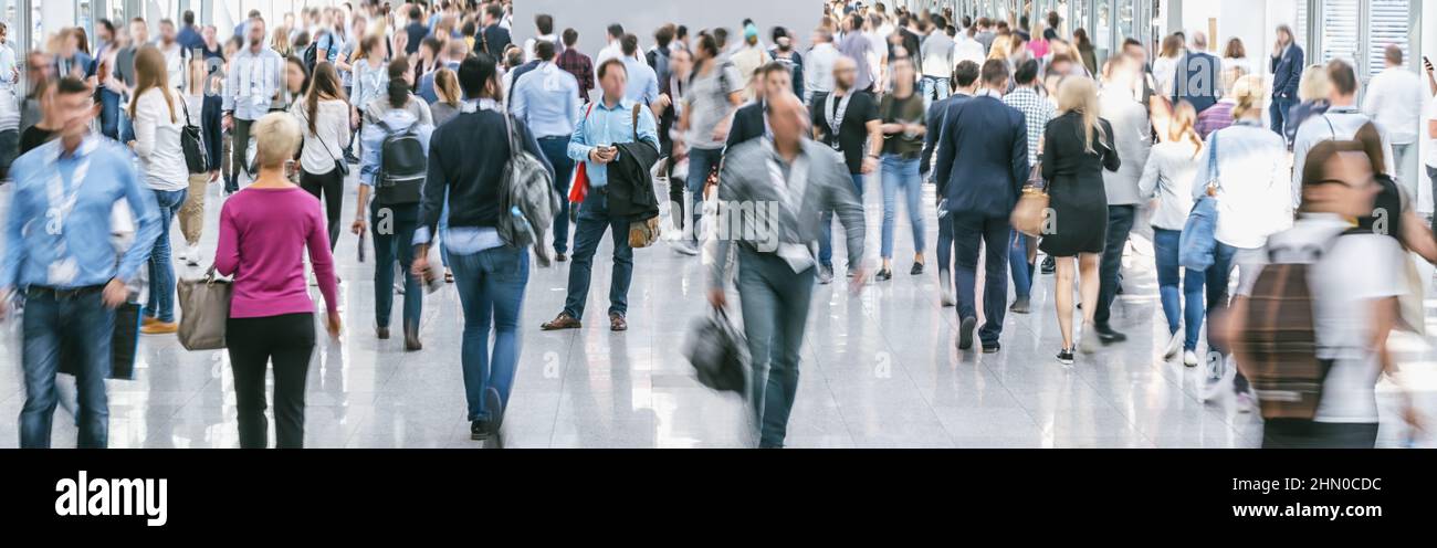 Crowd of people walking at trade fair Stock Photo - Alamy