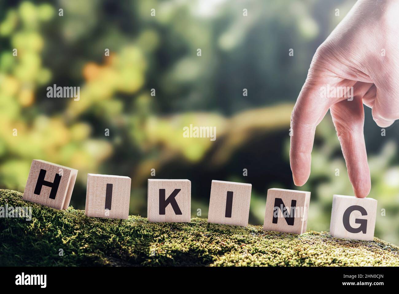 hiking word text on cubes on a forest background. Man walking, mountain ...