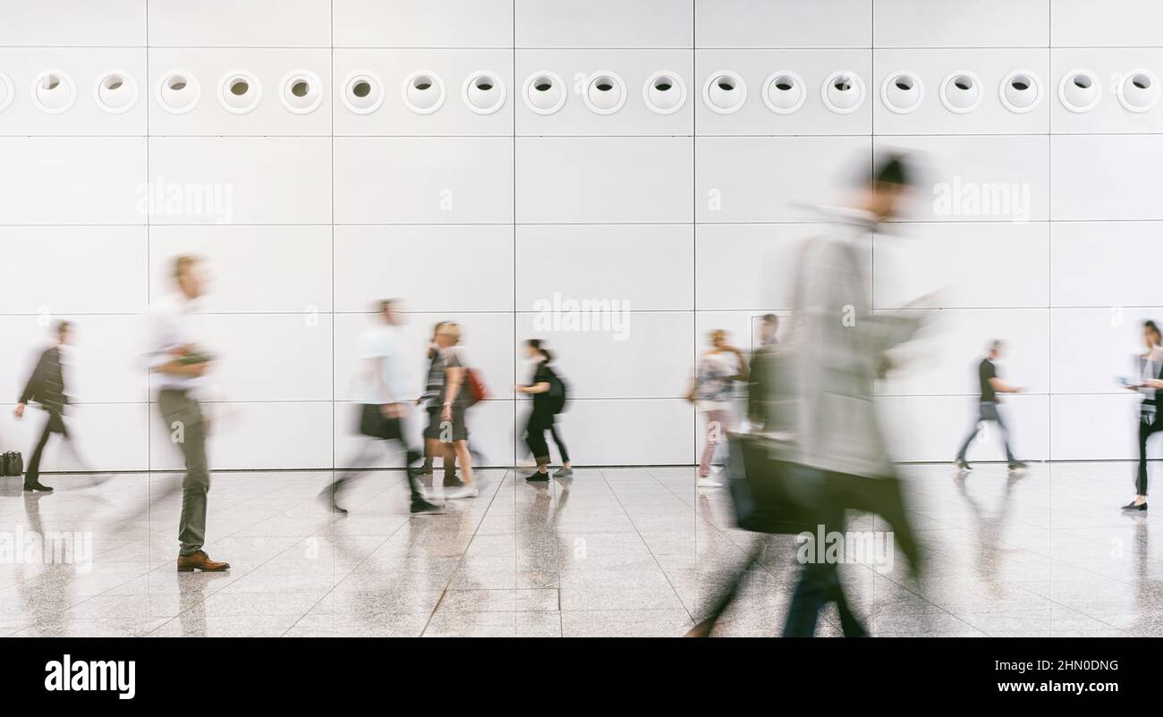 large crowd of anonymous blurred people walking in a modern hall Stock ...