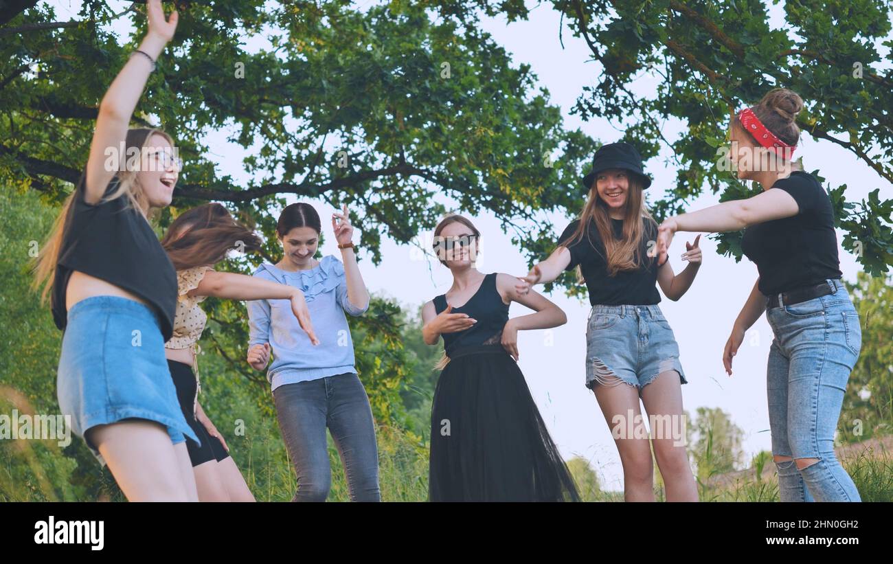 Girls are dancing outside the city on a picnic Stock Photo - Alamy