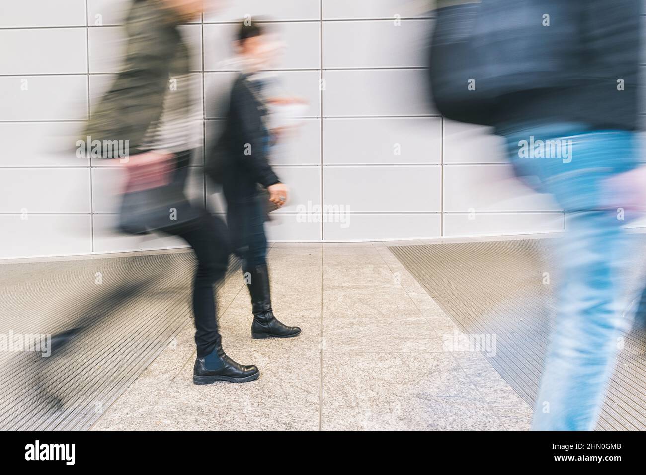 blurred anonymous pedestrian walking in a corridor Stock Photo - Alamy