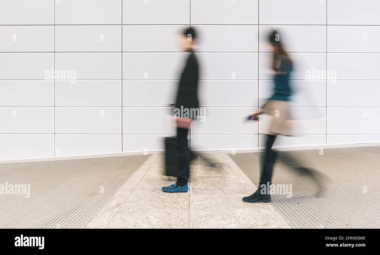 anonymous people walking in a corridor Stock Photo - Alamy