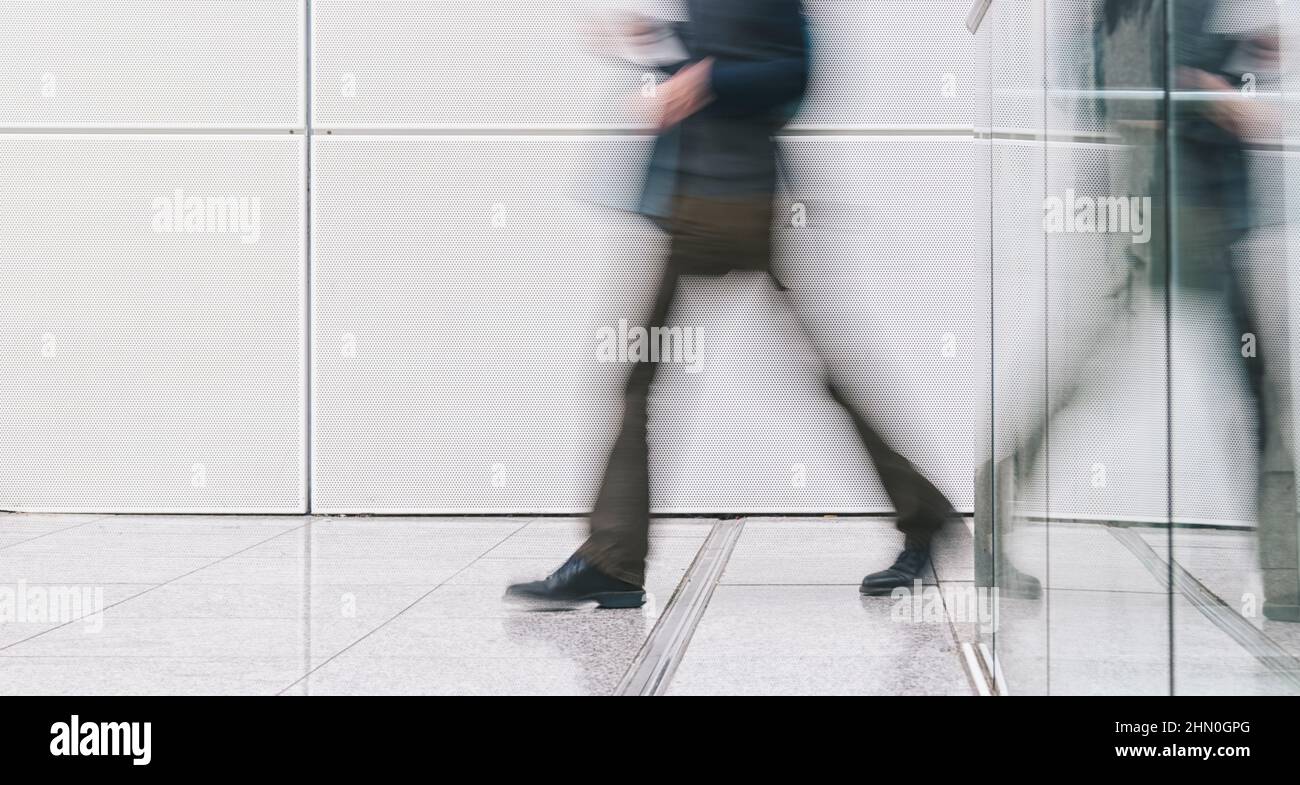 anonymous people rushing in a corridor Stock Photo - Alamy