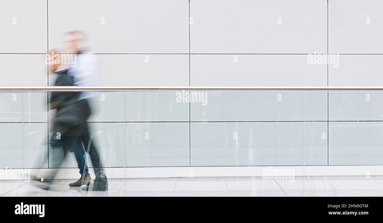anonymous business people walking in a corridor Stock Photo - Alamy