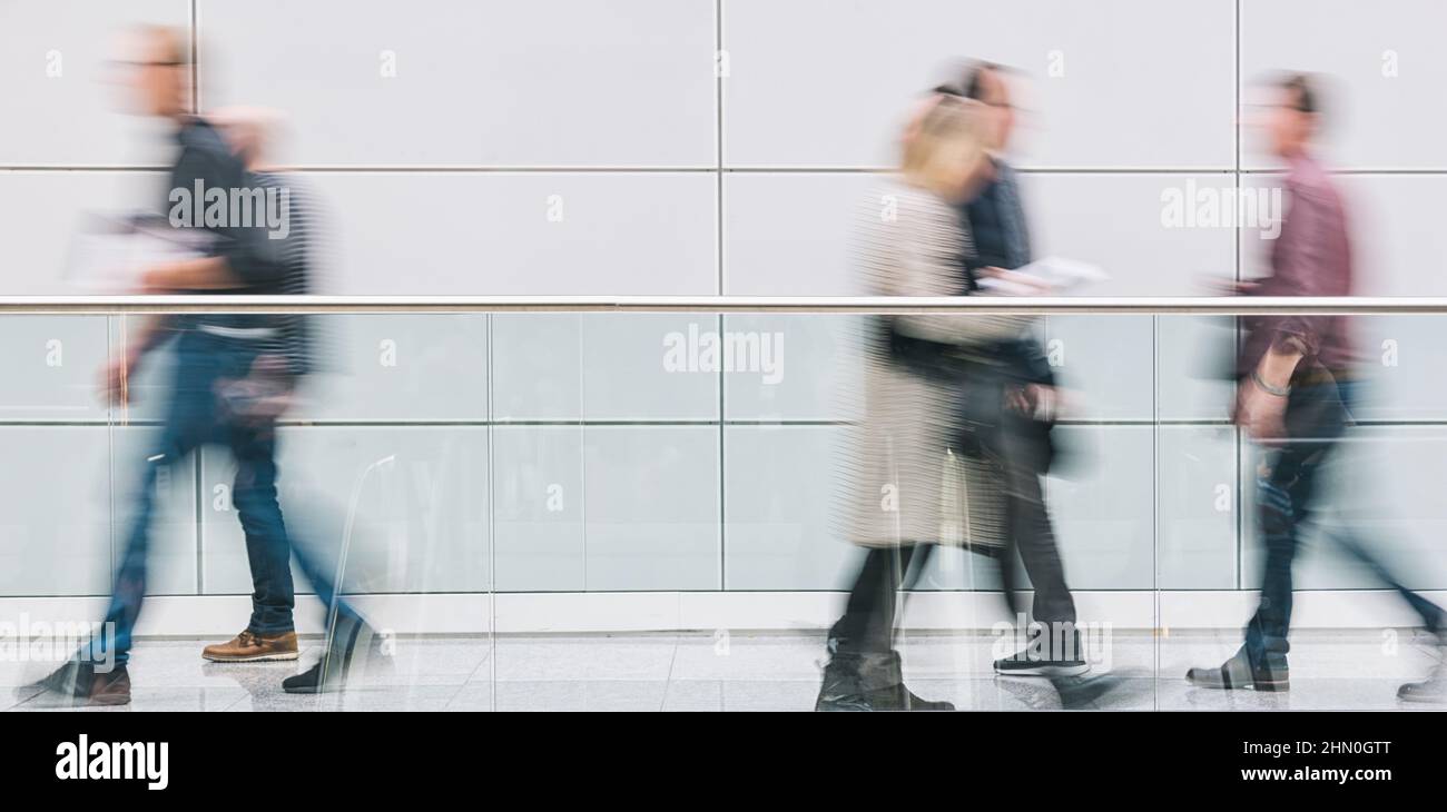 anonymous people walking in a corridor Stock Photo - Alamy