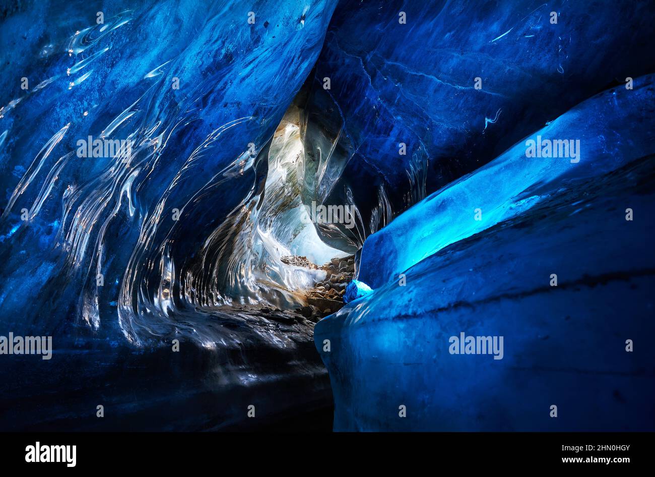 Landscape of amazing glacial ice cave with blue lights inside ice wall ...