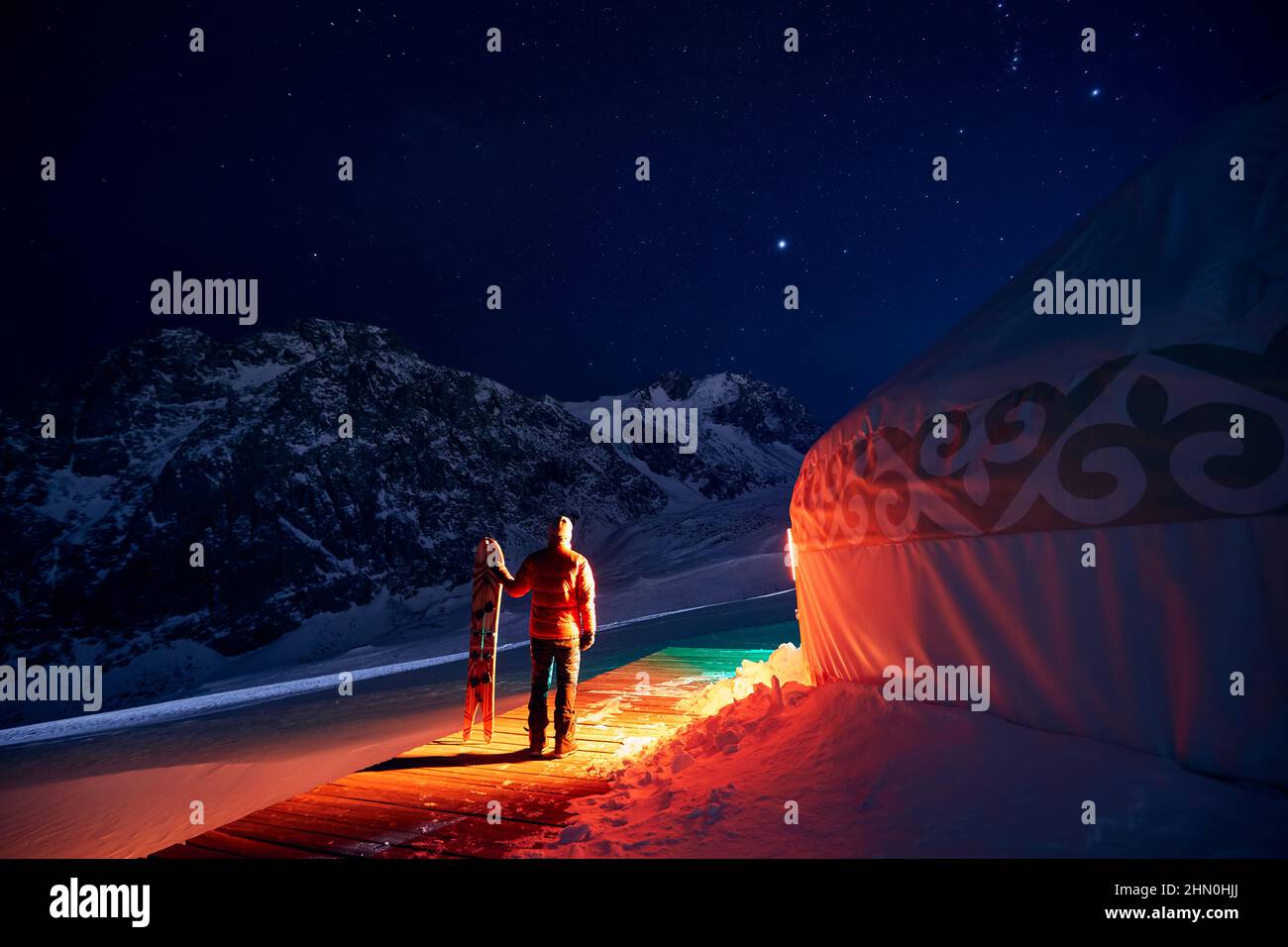 Man holding split snow board near Yurt nomadic house complex at Ski ...