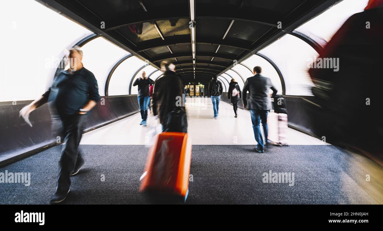 crowd of commuters rushing through in a airport terminal tunnel Stock ...