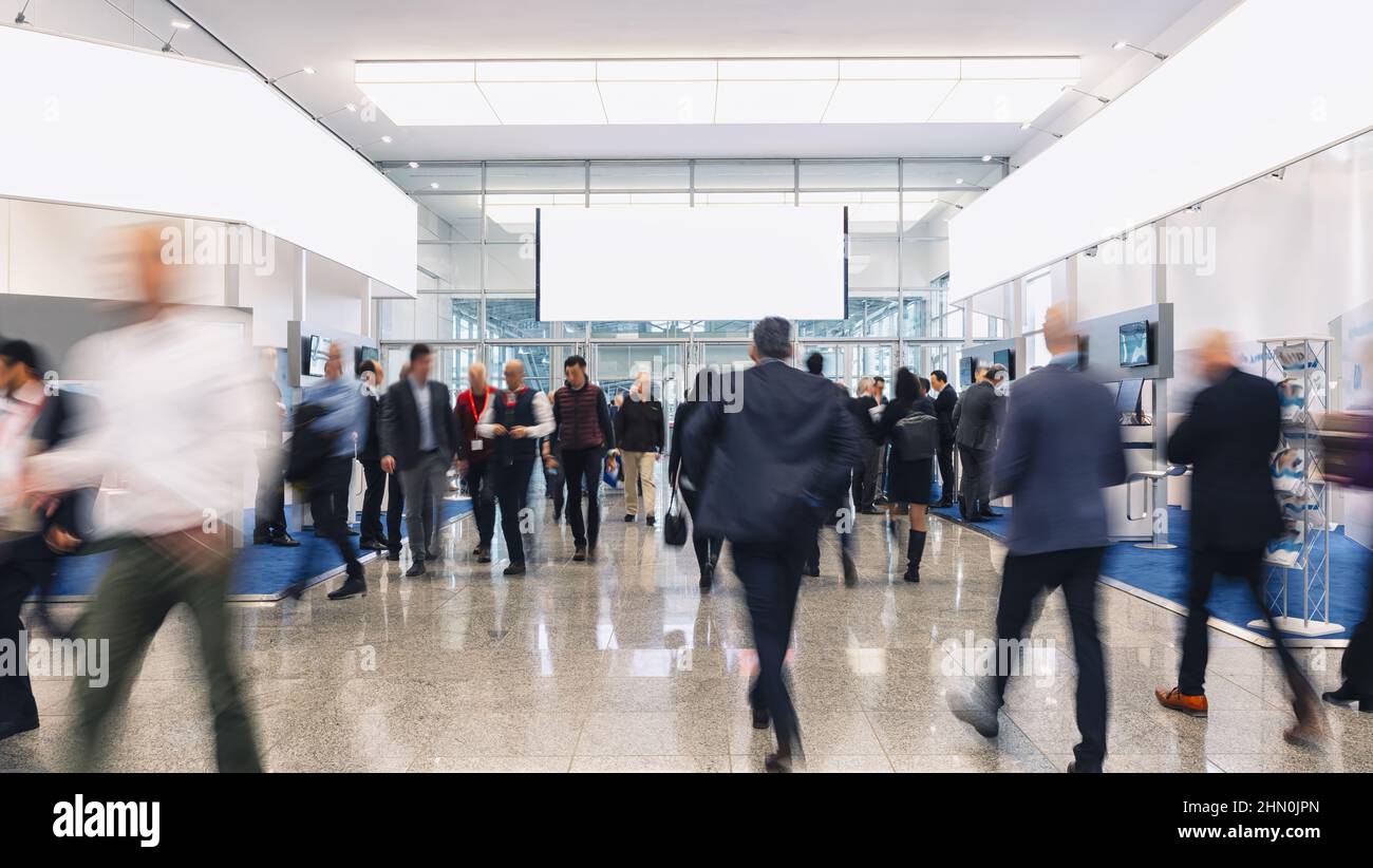 trade fair visitors walking in a clean futuristic corridor, copy space ...