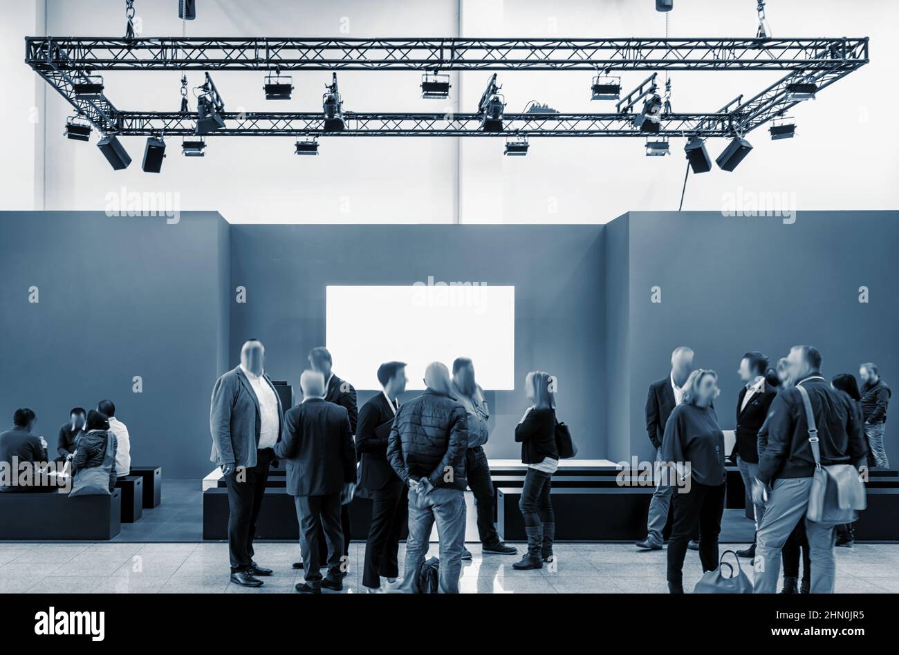 business people walking between trade show booths at a public event ...